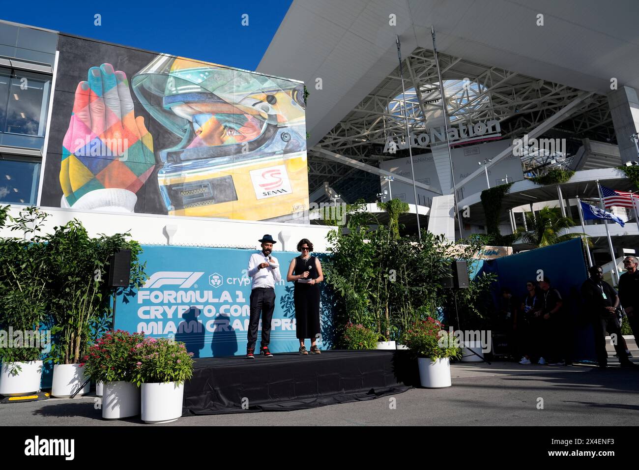 Artist Eduardo Kobra, center left, of Brazil, poses in front of his ...