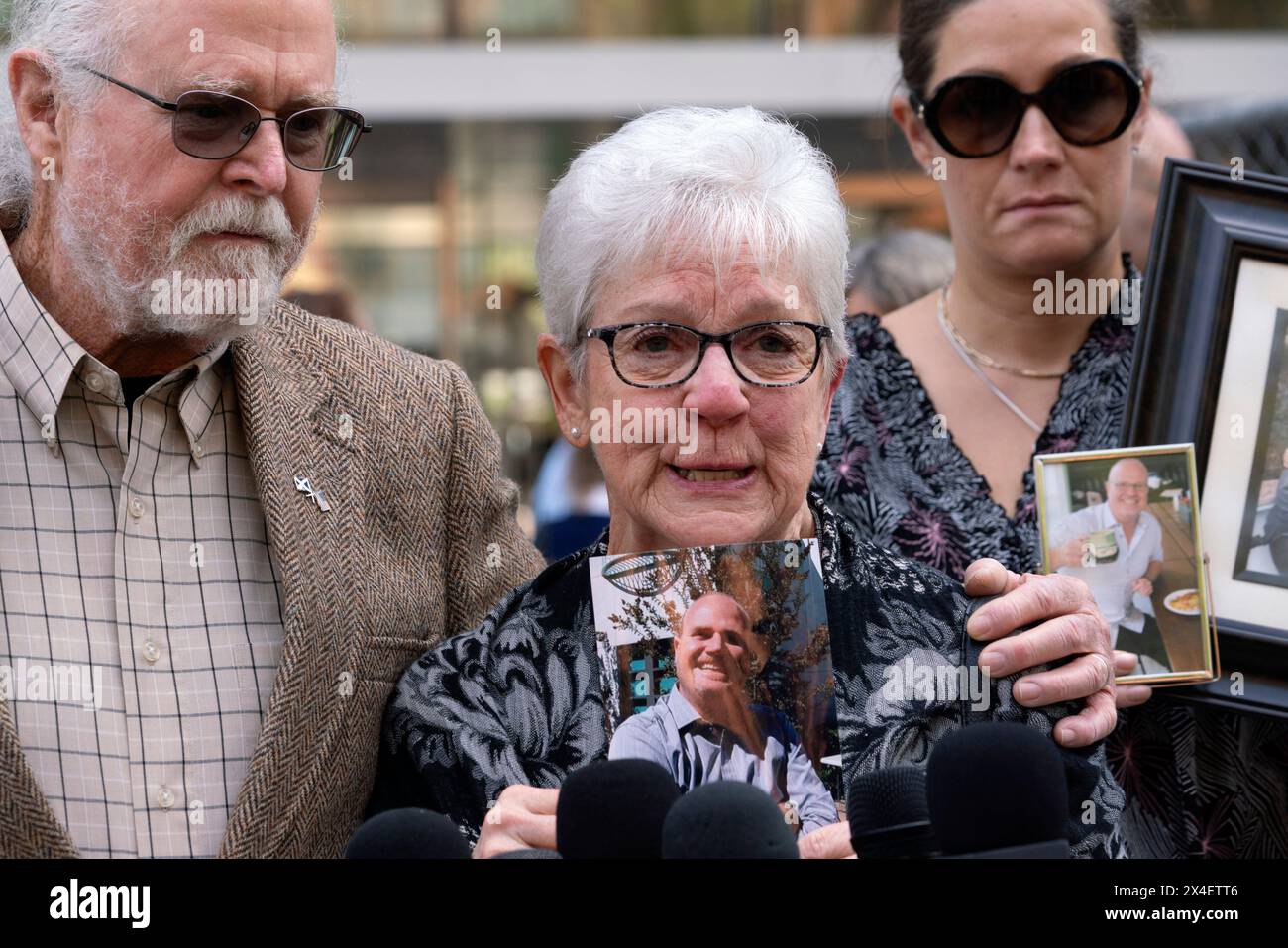 Kathleen Mcllvain sheds tears while holding a photo of her son Charlie ...