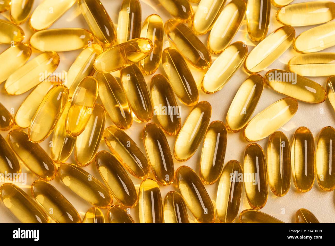 fish oil pills with omega 3 with a golden yellow color, an essential ...