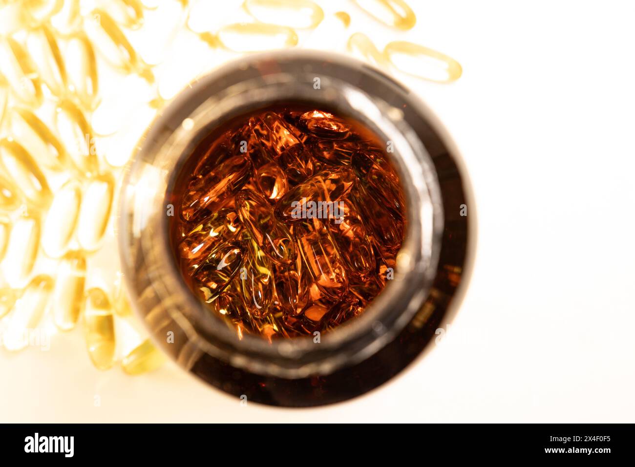 jar of fish oil pills with omega 3 with a golden yellow color, an ...