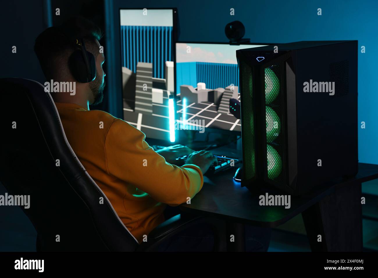 Man playing video games on computer indoors Stock Photo - Alamy