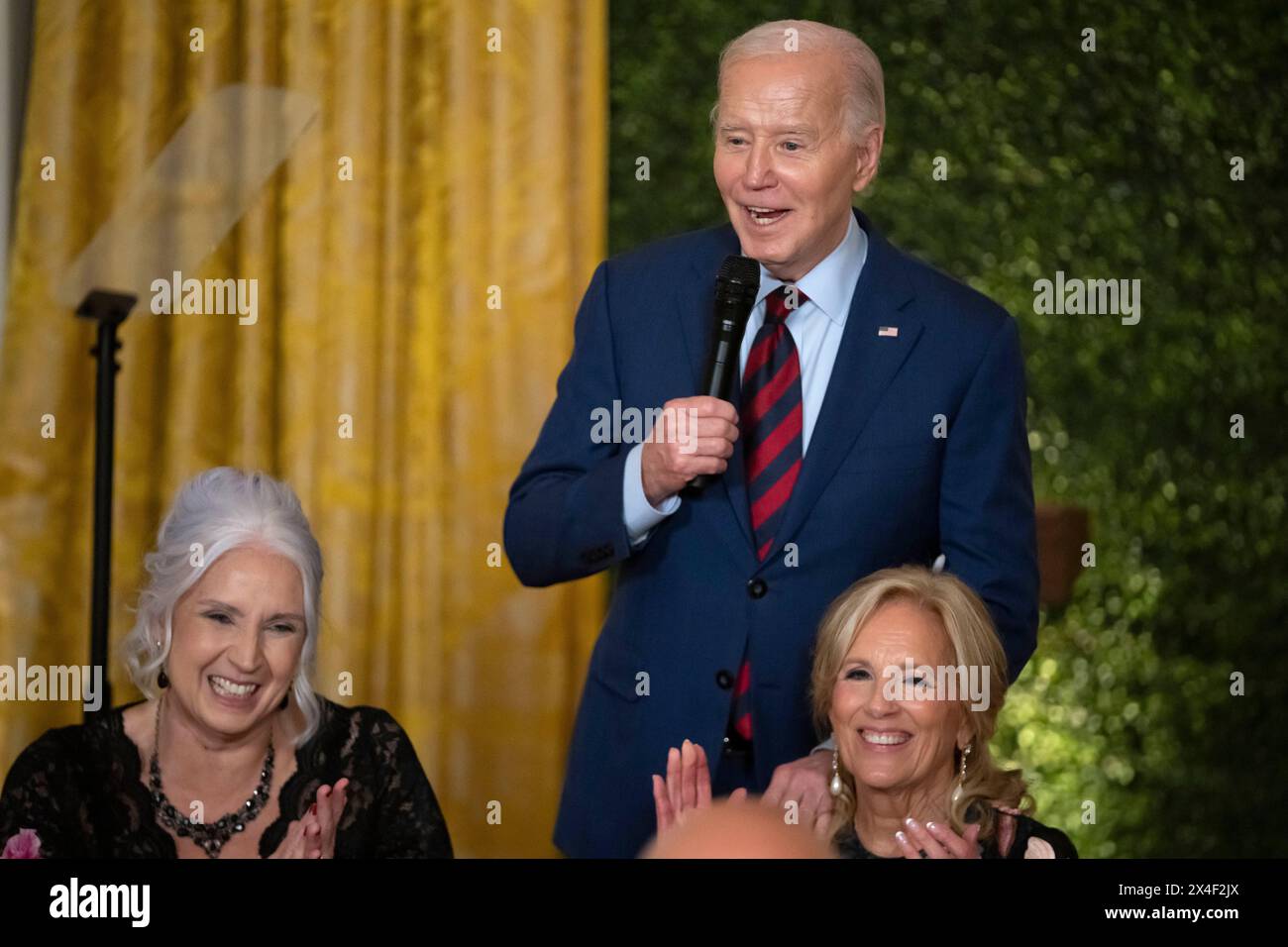 President Joe Biden speaks as Missy Testerman, bottom left, the 2024 ...
