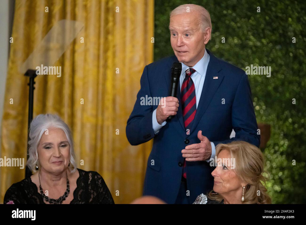 President Joe Biden speaks as Missy Testerman, bottom left, the 2024 ...
