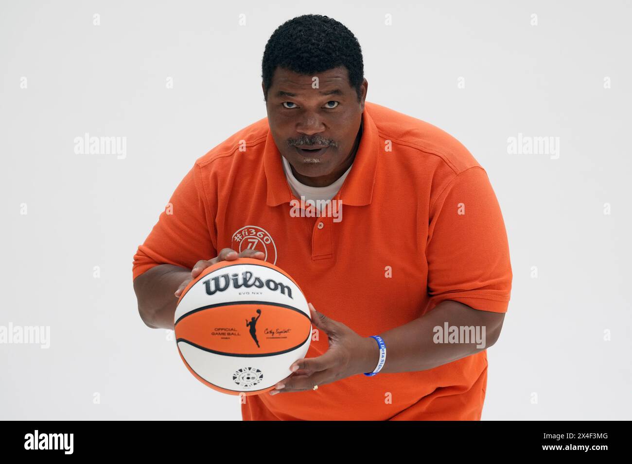 Jevone Moore aka Orange Man and Mr. Orange poses with a WNBA basketball ...
