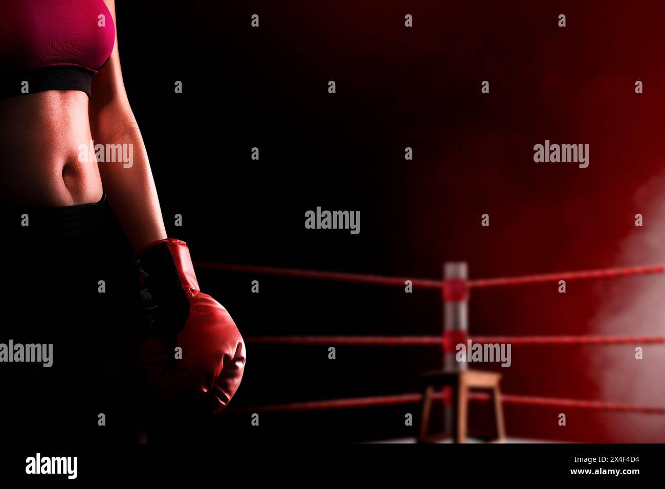 Portrait of a boxing woman with red boxing gloves in the boxing ring ...
