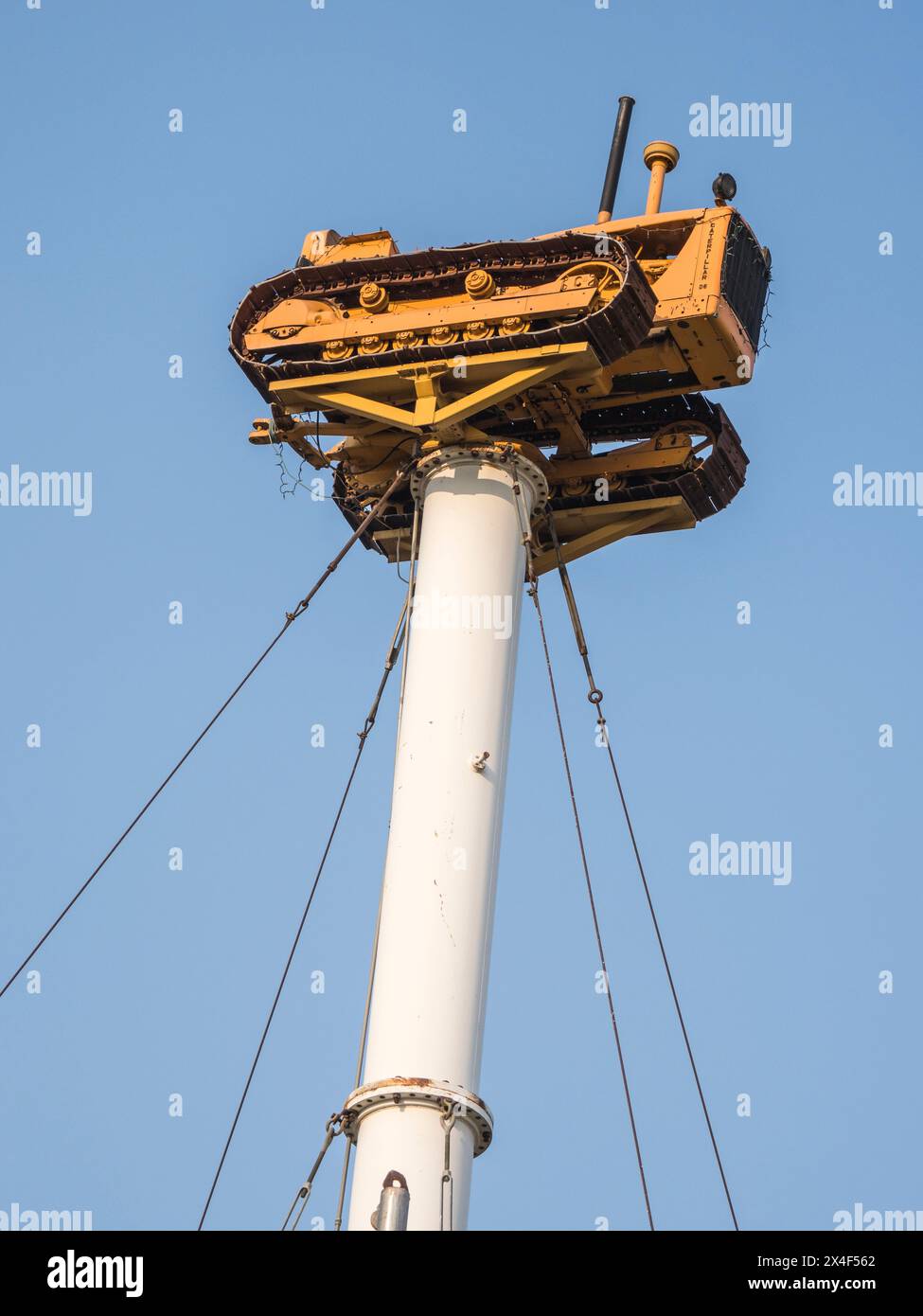 Tractor sits on pole held in place by guide wires in the Palouse Stock ...