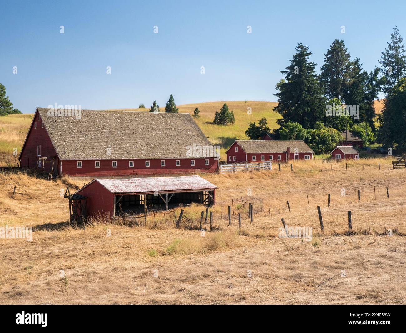 Red barn surrounded by dried grasses in summer. (Editorial Use Only ...