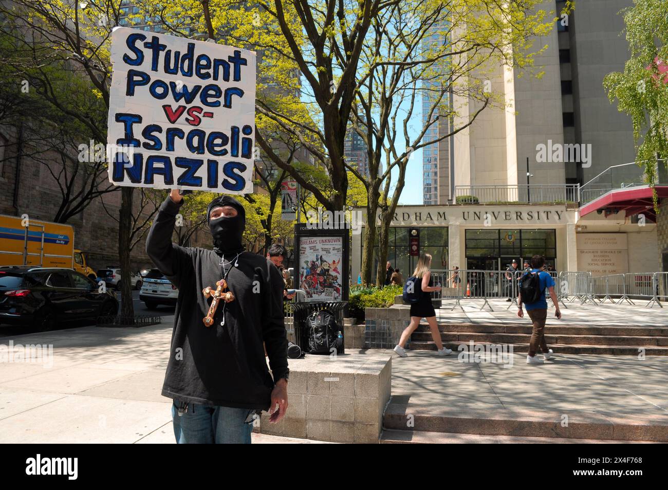 A pro-Palestine protester is seen holding a placard expressing his ...