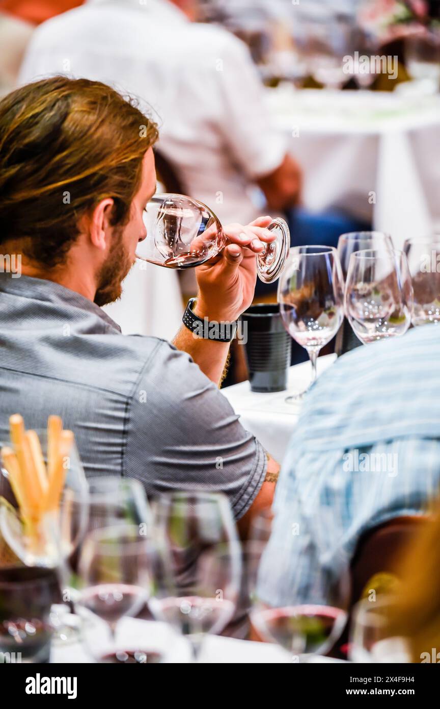 USA, Washington State, Walla Walla. Man samples Cabernet Sauvignon at ...