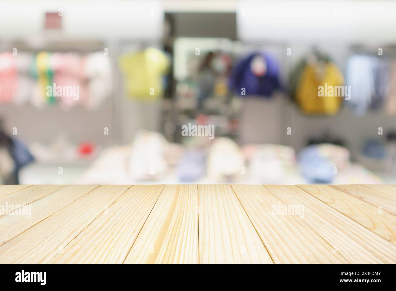 Empty wood table with blur kid fashionable boutique clothing store ...