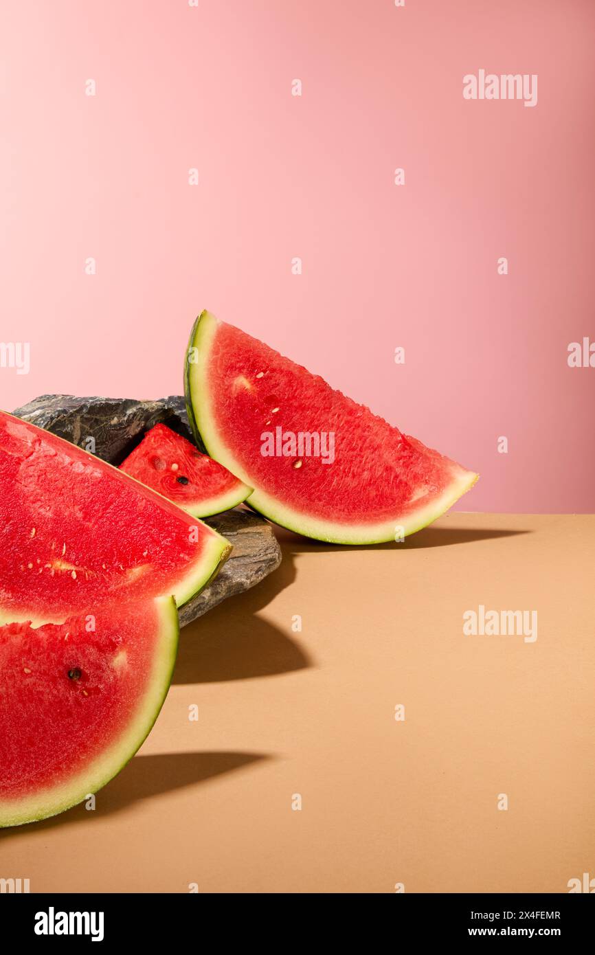 Front view of juicy watermelon slices decorated on a pink background ...