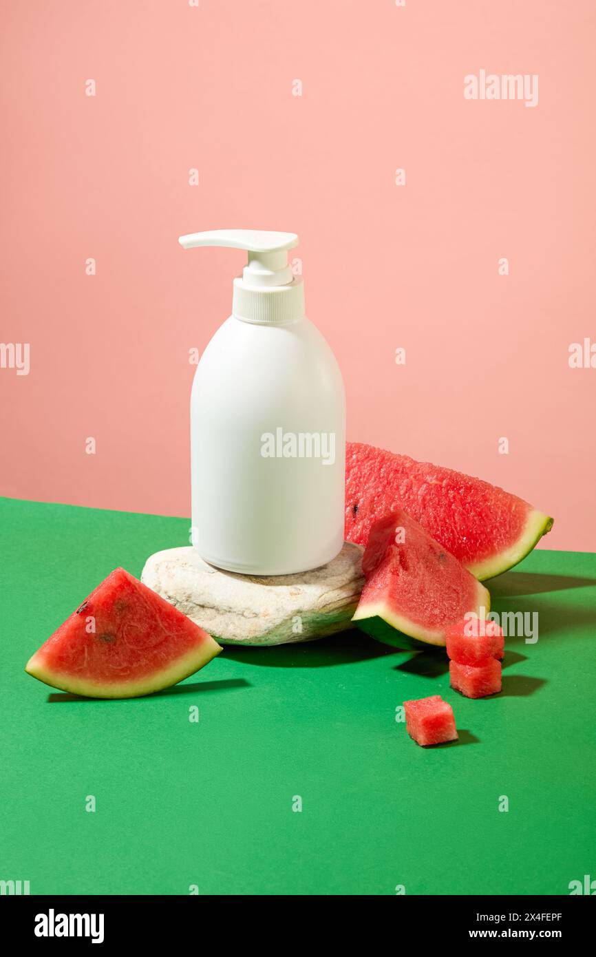 Advertising photo for cosmetic of watermelon extract. A white pump bottle without label ...
