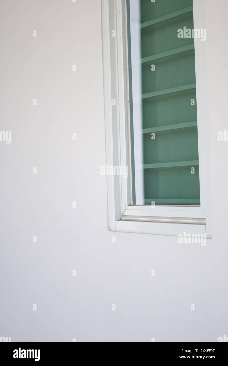Minimalist background of a long glass window with green curtains and ...