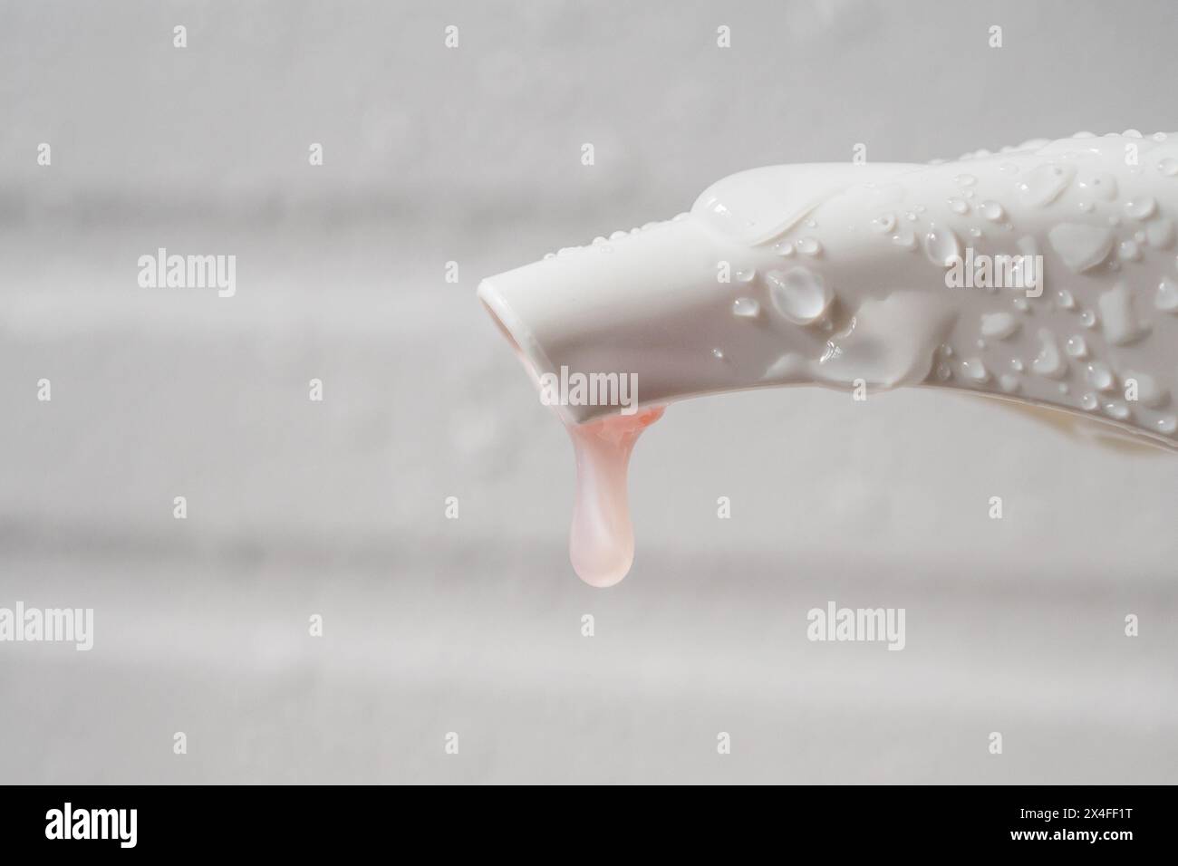 Water drop on liquid soap dispenser pump during bath time Stock Photo ...