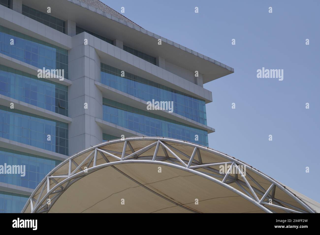 A building with a roof like a snail shell and a white building with ...