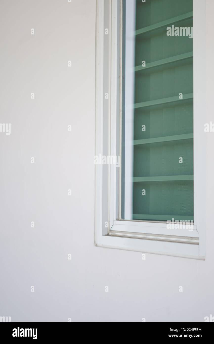 Minimalist background of a long glass window with green curtains and ...