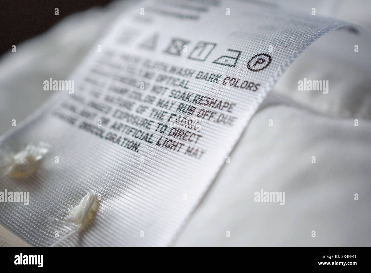 Cloth label tag with laundry care instructions Stock Photo - Alamy