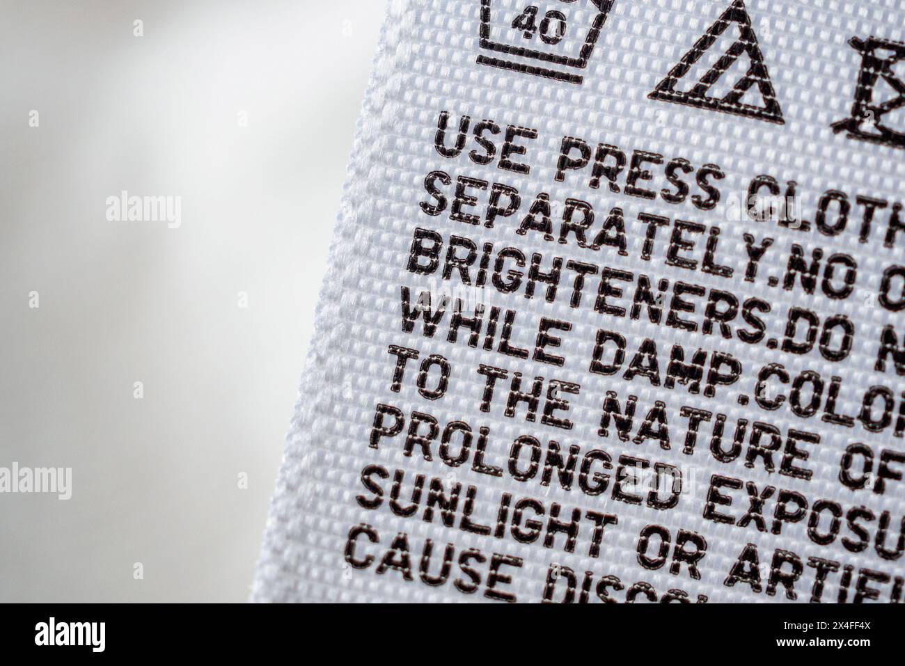 Cloth label tag with laundry care instructions Stock Photo - Alamy