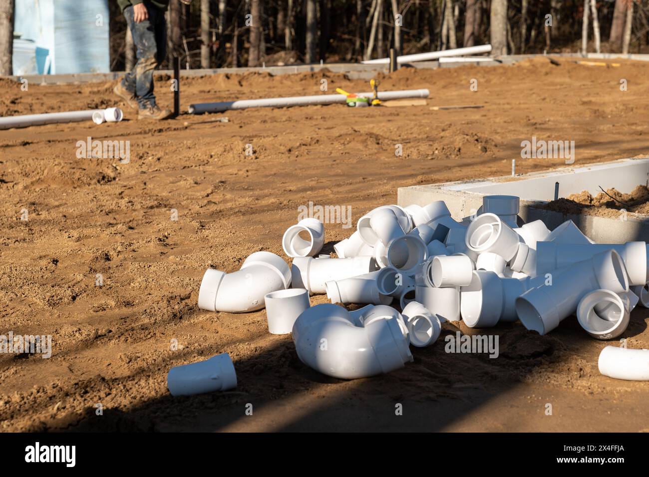 Preformed plastic or PVC elbows sitting in the dirt, ready for ...