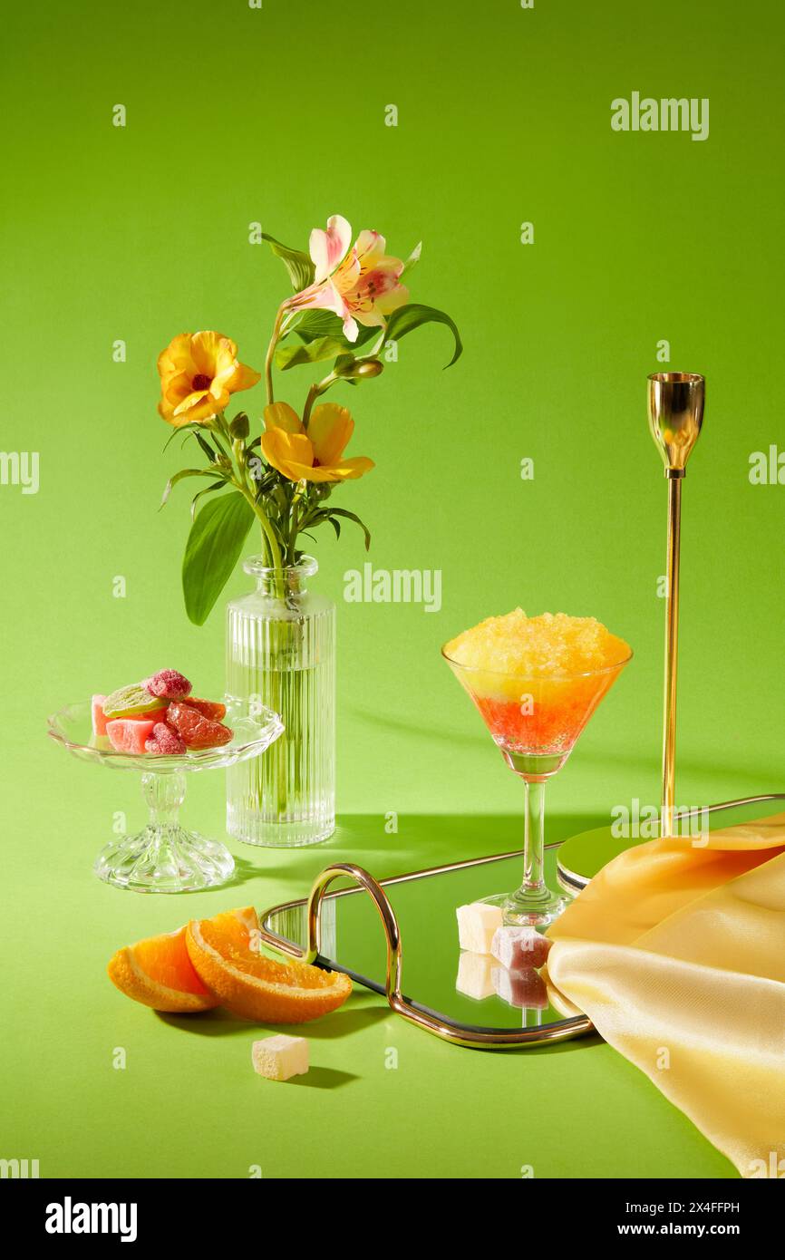Front view of delicious smoothie cups, orange slices and jams on mirror ...