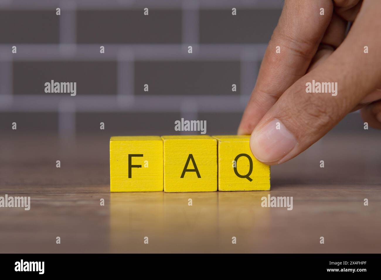 Wooden cubes with alphabet FAQ. Frequently asked questions concept ...