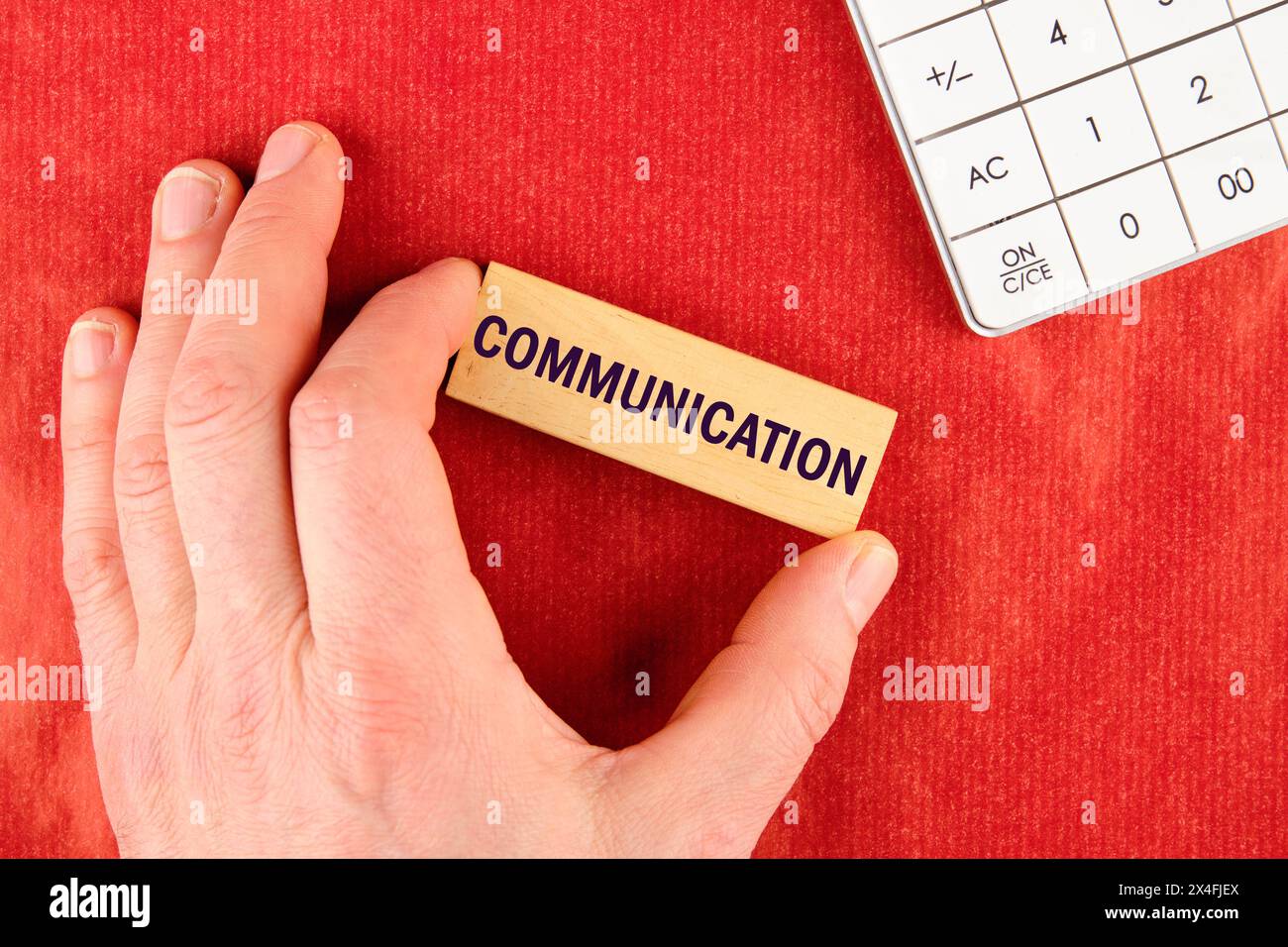 COMMUNICATION word written text is made up of wooden blocks on a red ...