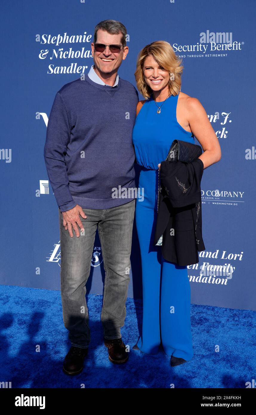 Los Angels Chargers head coach Jim Harbaugh and his wife Sarah pose ...