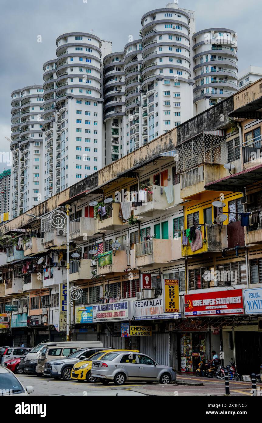 A stark contrast between towering modern apartment buildings and ... A stark contrast between towering modern apartment buildings and ...