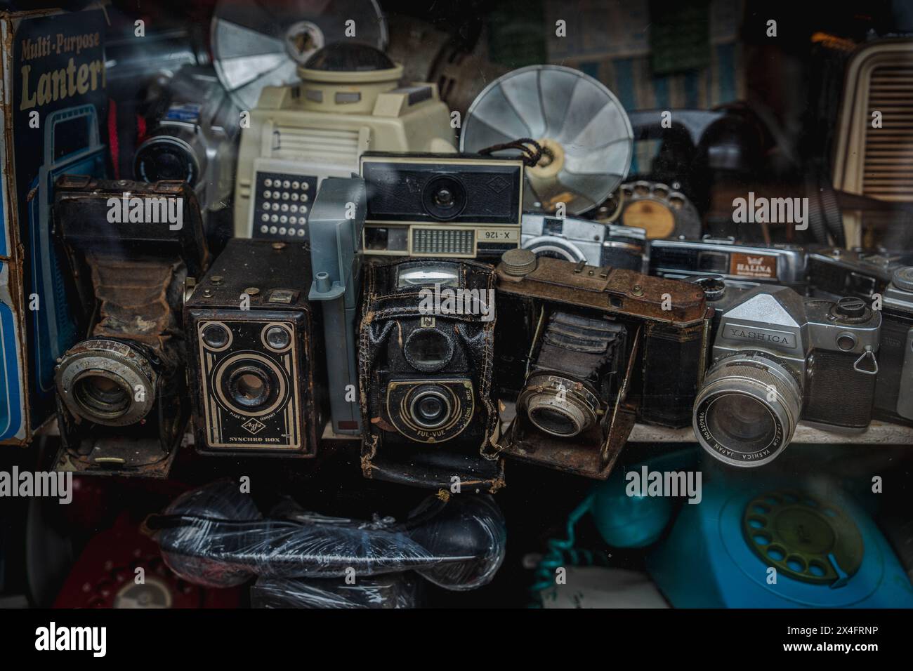 A collection of vintage cameras and other old electronic gadgets ...