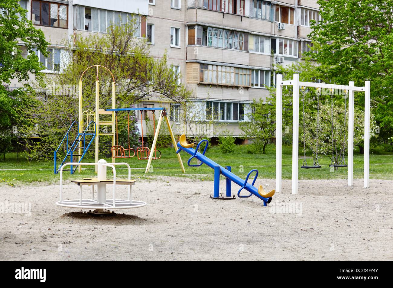 Colorful playground on yard with no children. Play yard with swing and ...