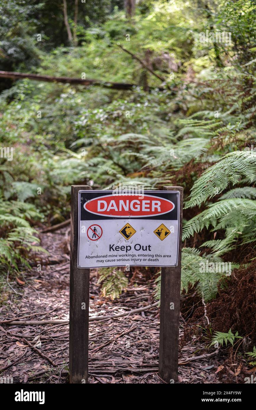 Danger sign in the forest Stock Photo - Alamy