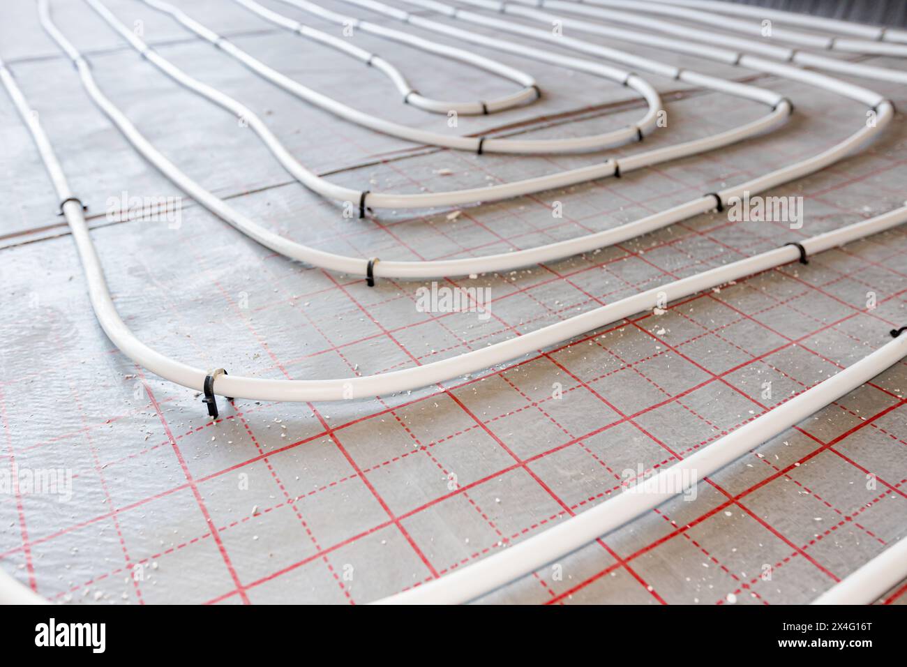 Low angle view on thin white tubes bended in complex curve of new brass ...