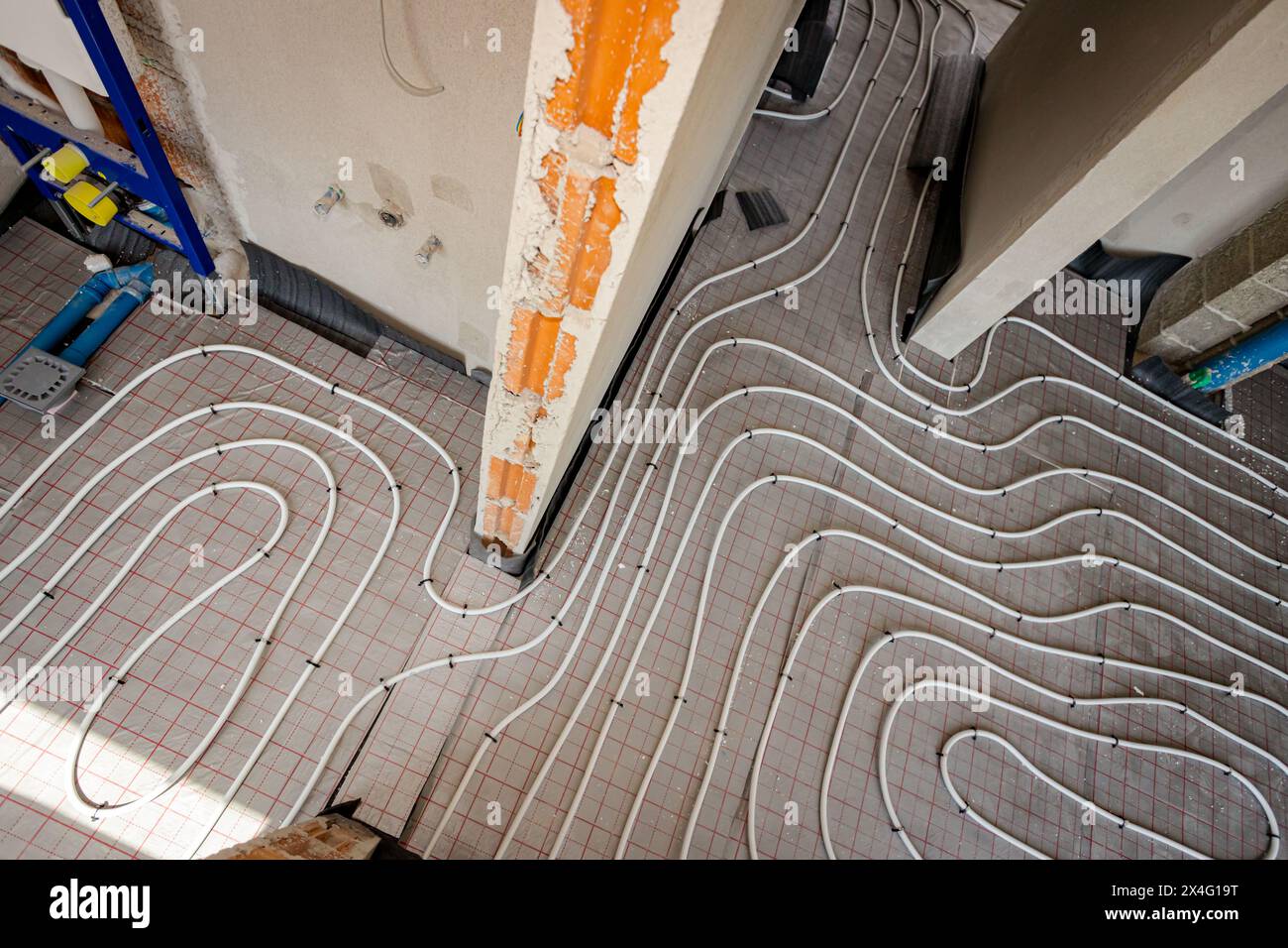 Thin white tubes are bended in complex curve of new brass, distribution ...