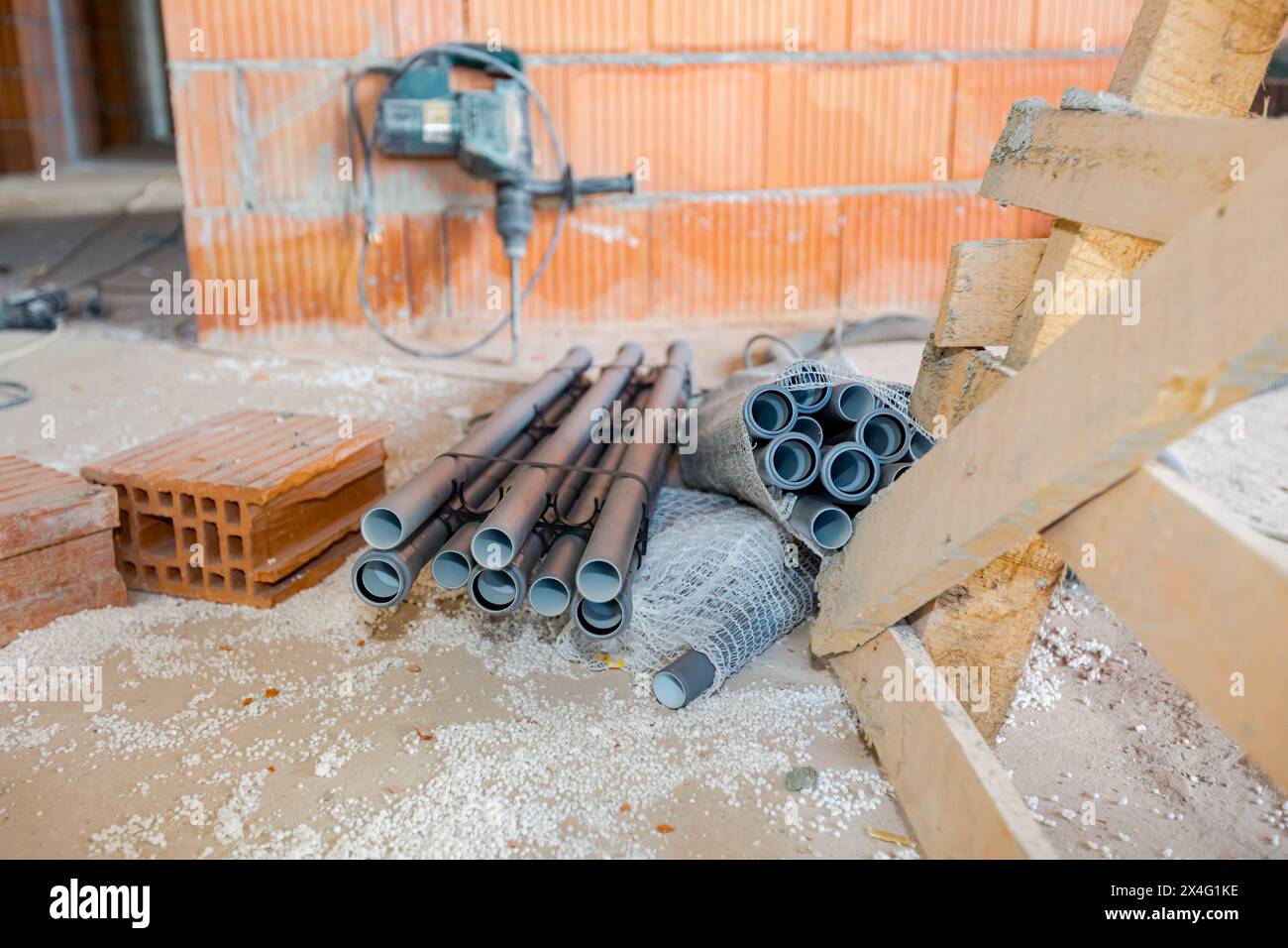 Package of new grey plumbing sewer pipes placed on the floor waiting to ...