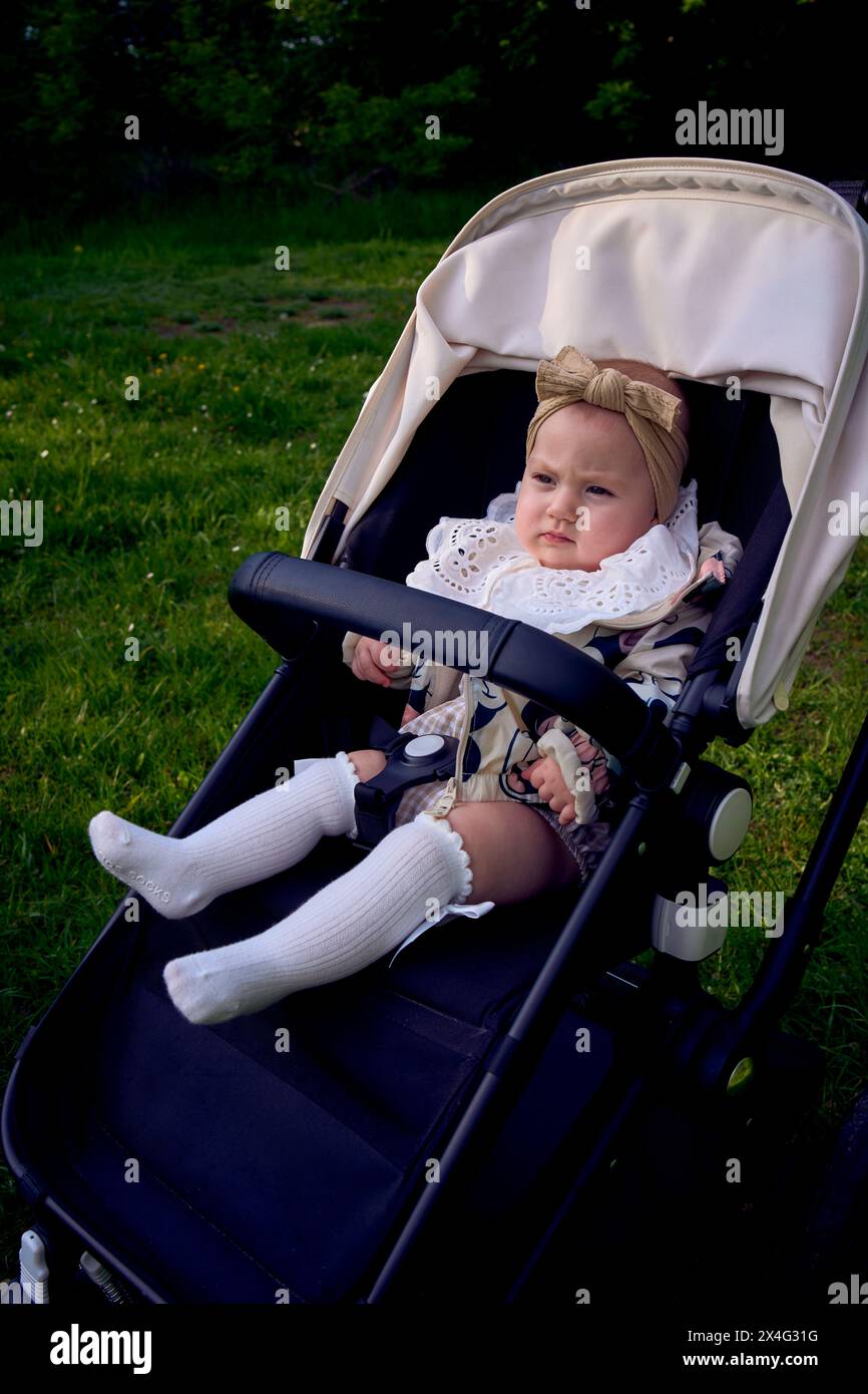 cute baby girl in a stroller in the park Stock Photo - Alamy