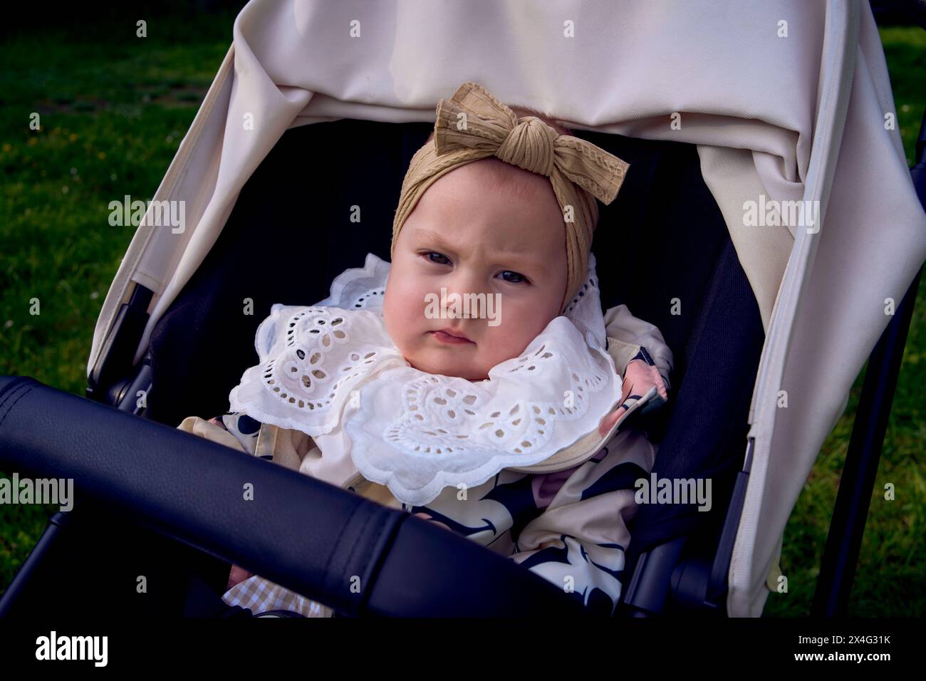 cute baby girl in a stroller in the park Stock Photo - Alamy