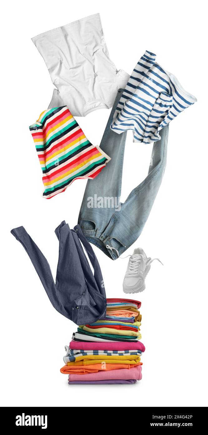 Laundry day. Different flying clothes over stacked ones on white ...