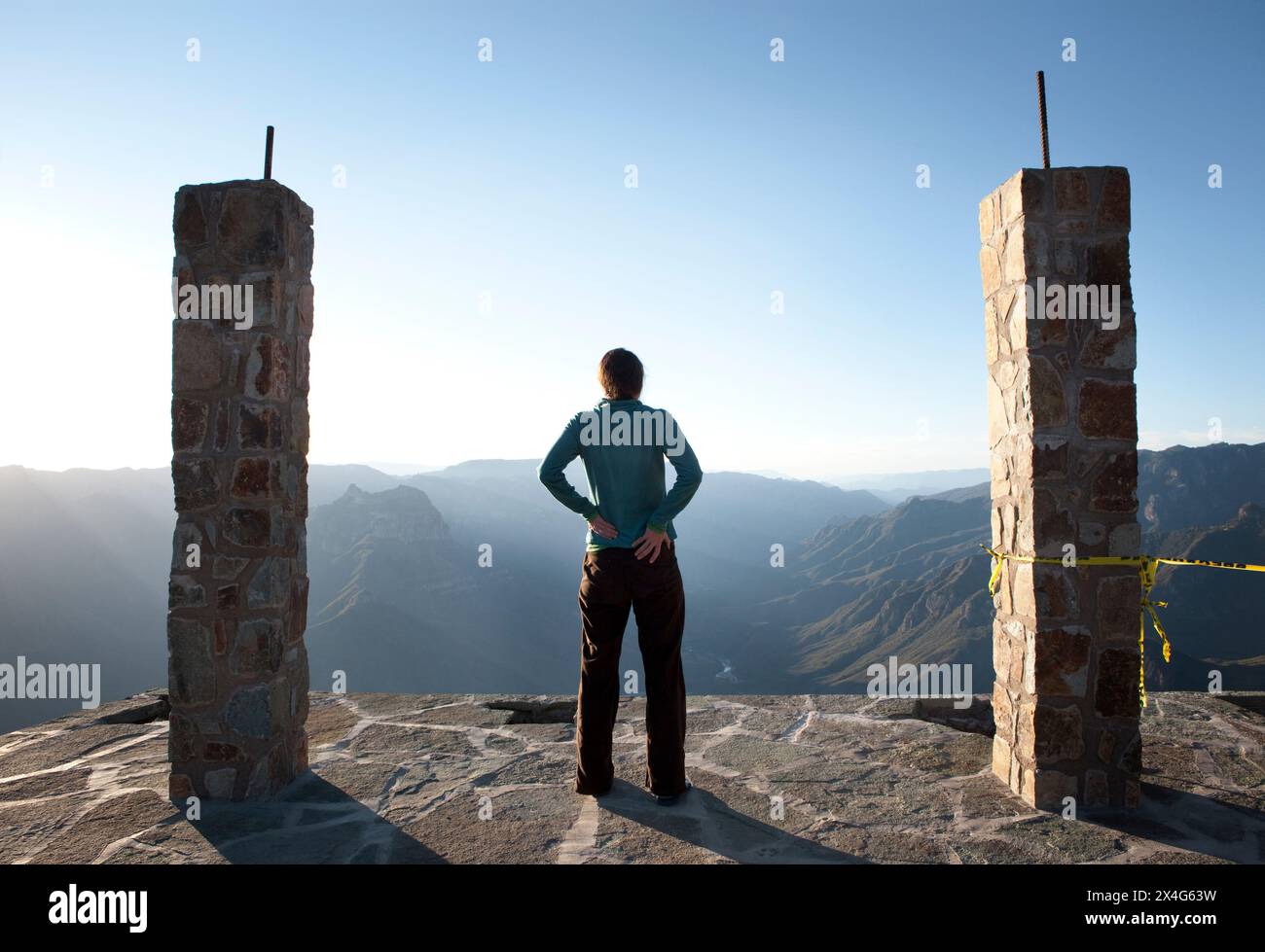 A runner stretches and looks out over the Copper Canyon, Mexico Stock ...