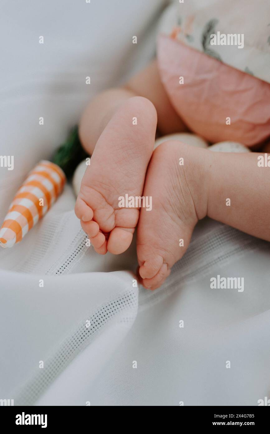 Tiny feet and Easter treats; baby's first holiday delights Stock Photo ...
