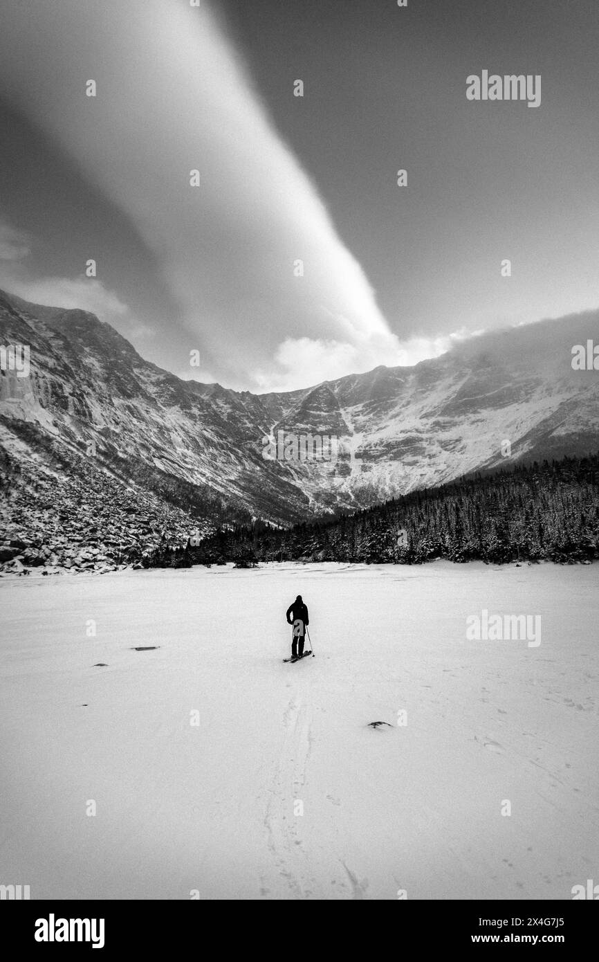 Skier stands in front of Katahdin with spectacular clouds, winter Stock ...