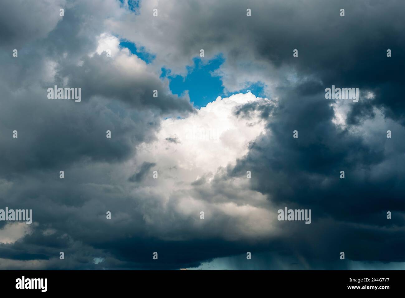 Dark rainy clouds and a small gap of blue sky, background Stock Photo ...