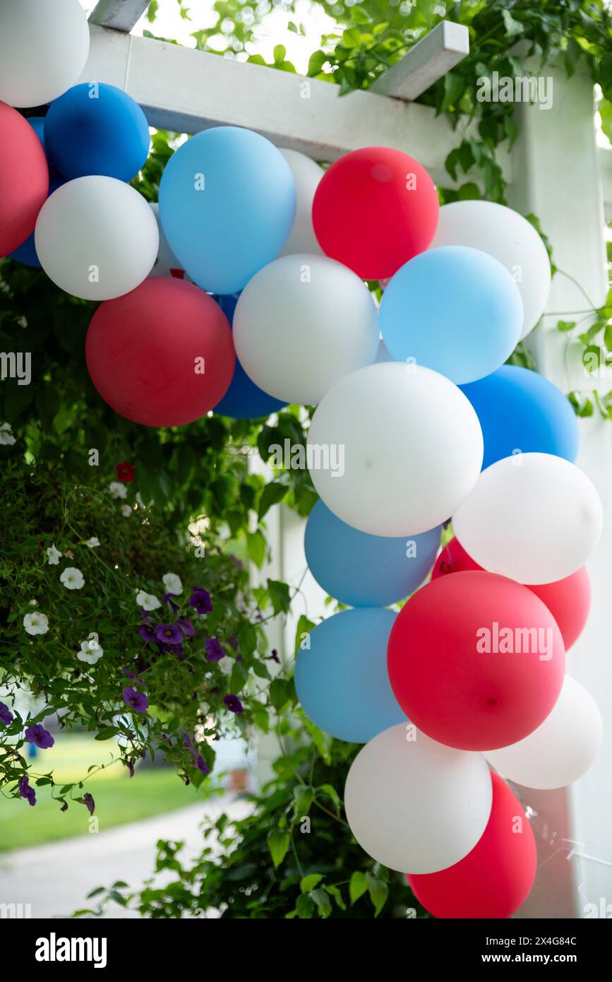 Red, white, and blue balloon decoration on garden arch close up Stock ...