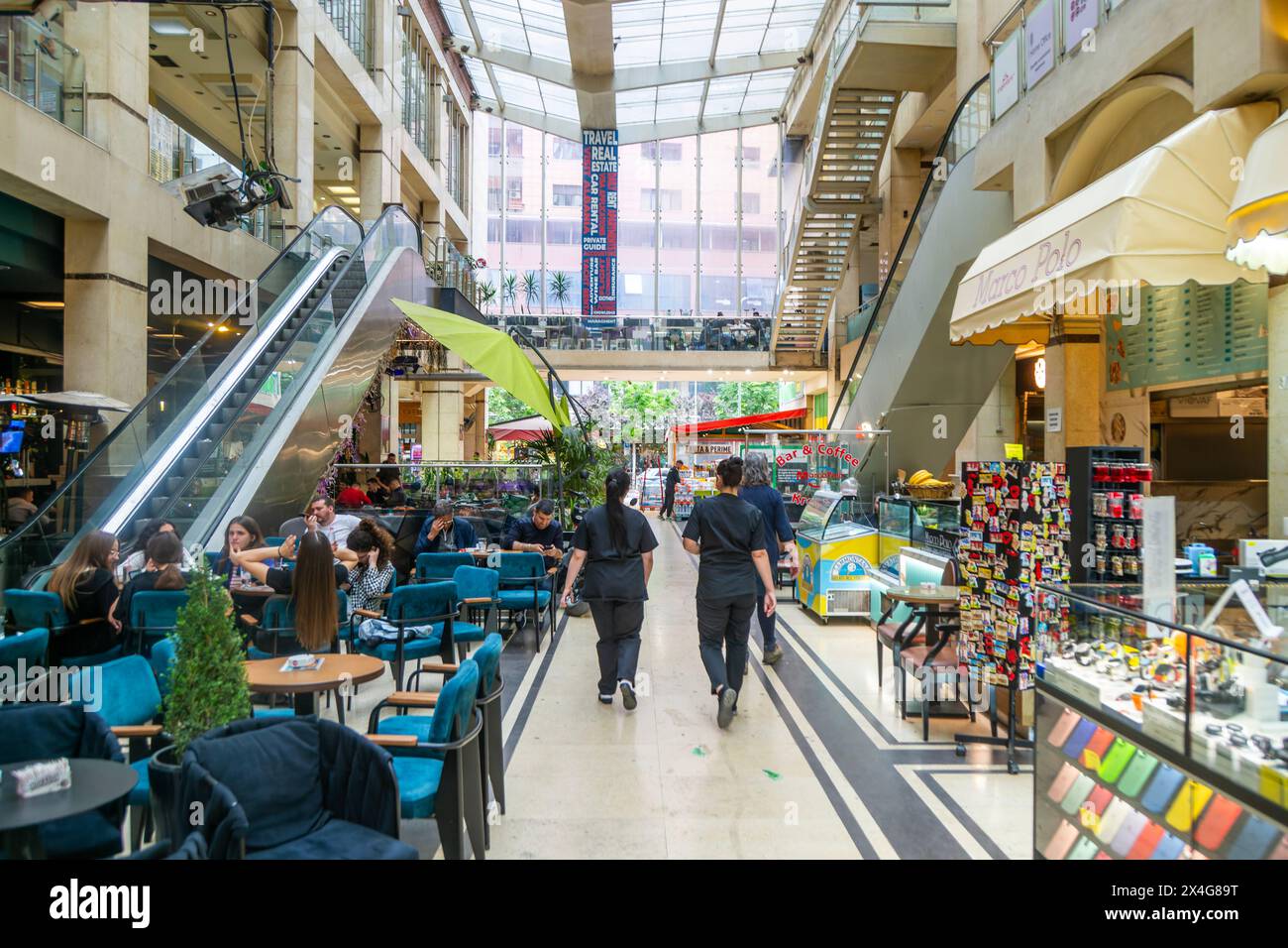 Shops and people inside shopping mall Galeria 17 Nëntori in city centre ...