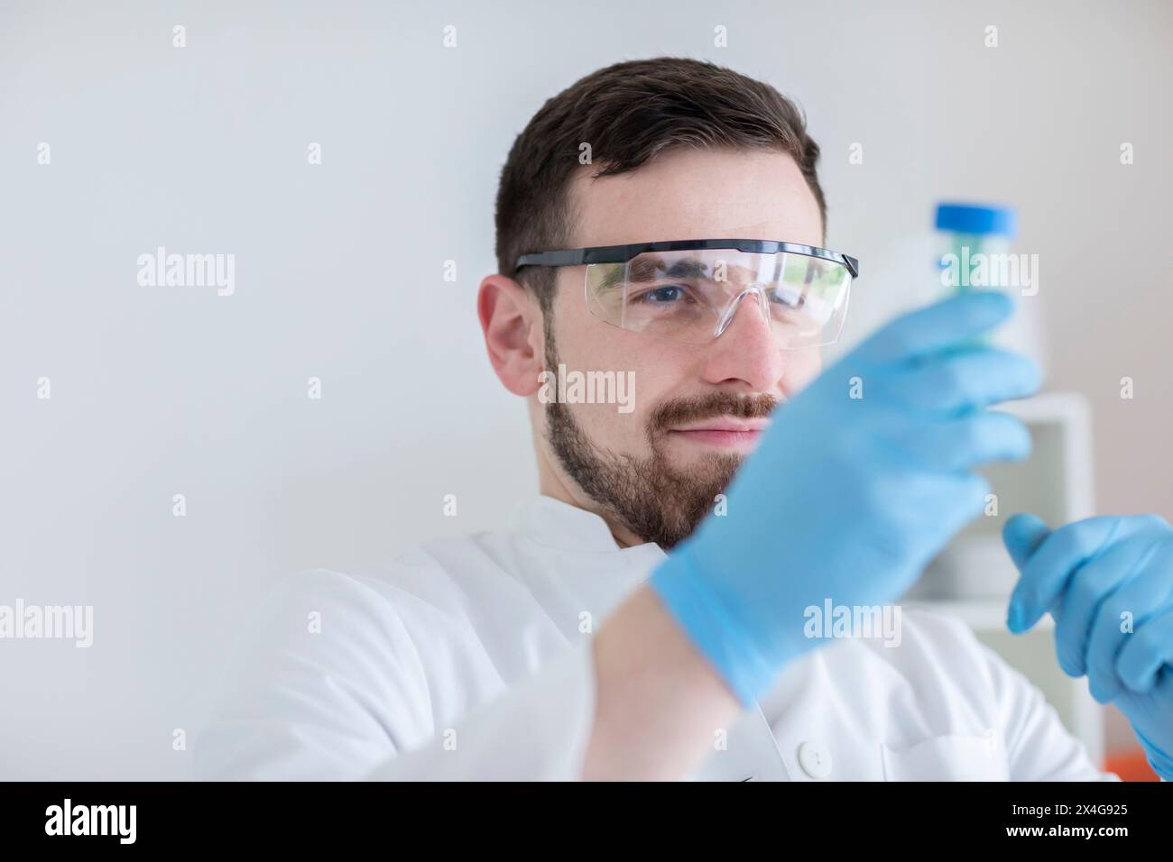 Scientist in lab coat gloves hi-res stock photography and images - Alamy