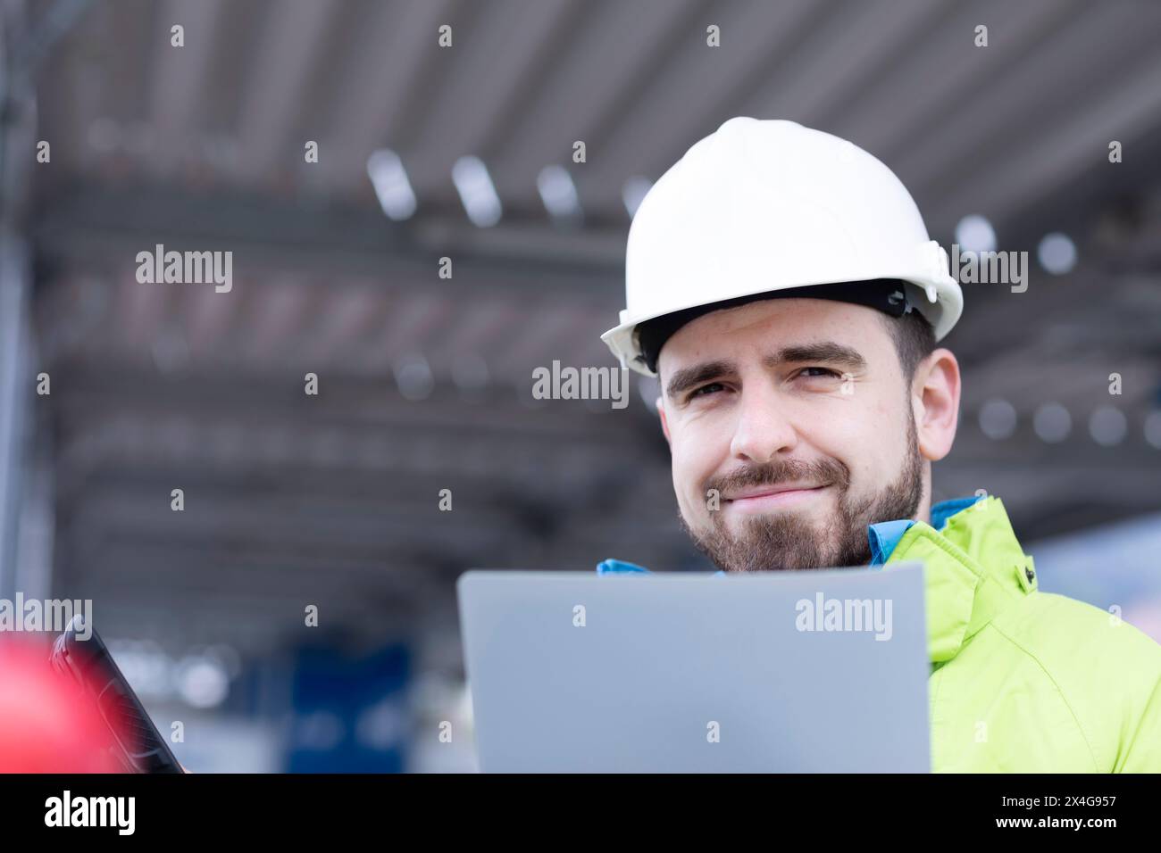 engineer male with helmet and beard controlling protocol Stock Photo ...
