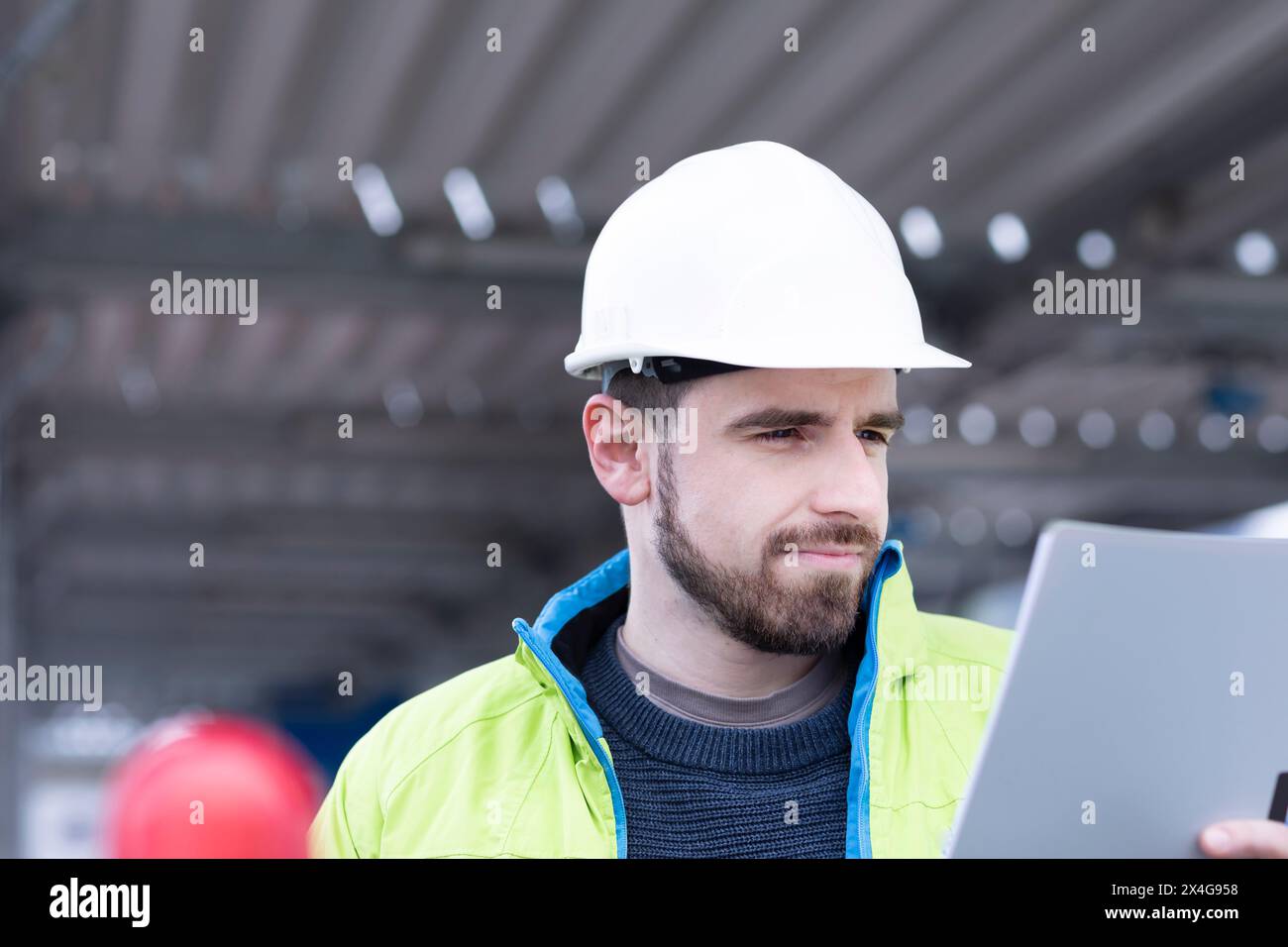engineer male with helmet and beard controlling protocol Stock Photo ...