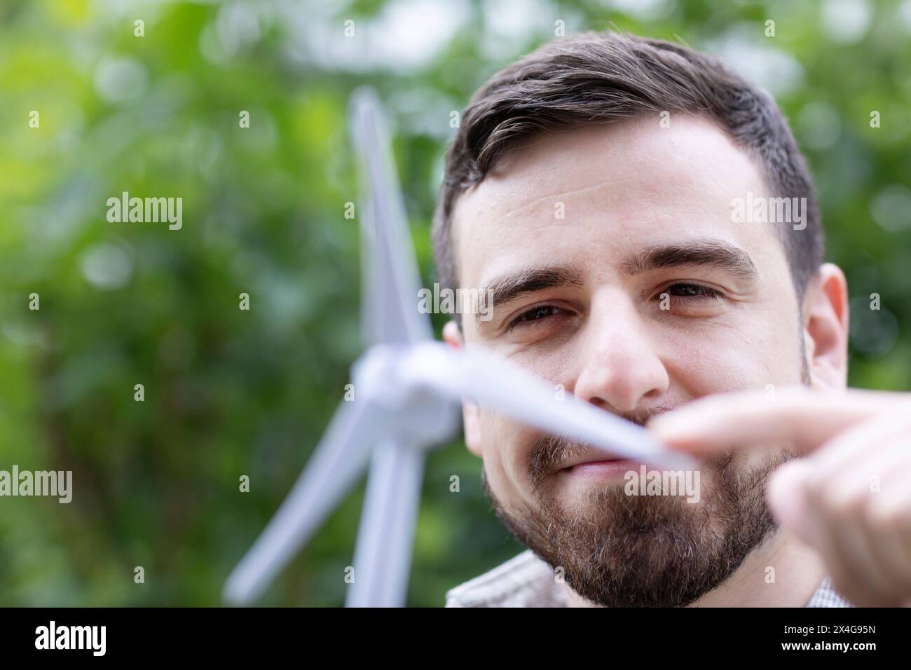 young man with windmill model in the hands Stock Photo - Alamy