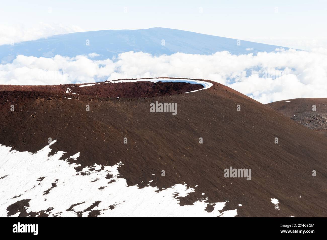 Hawaiian snow-capped volcanic crater above the clouds Stock Photo - Alamy