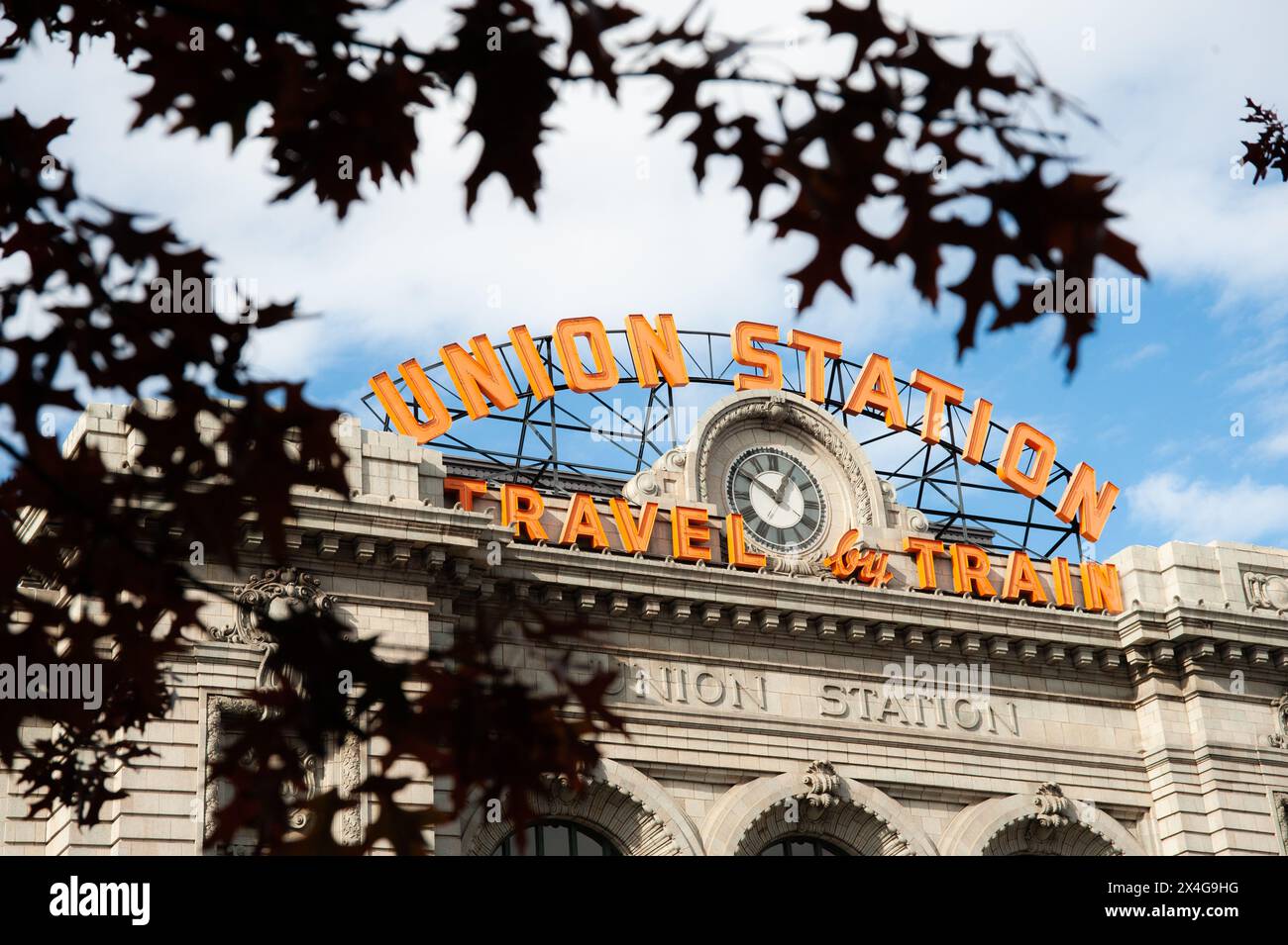 Historic Denver Union Station sign through autumn leaves Stock Photo ...