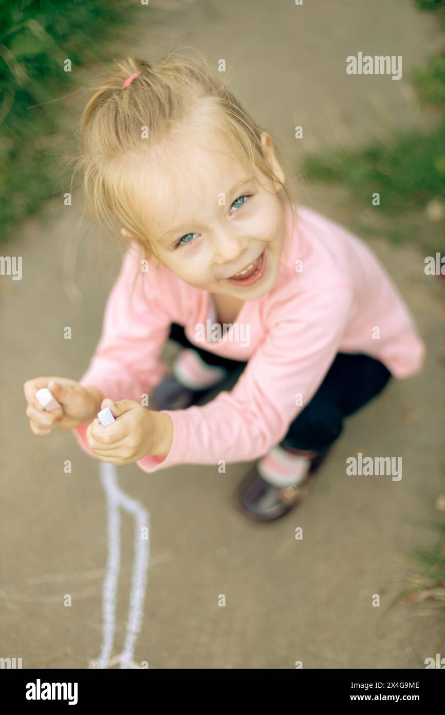 Little child playing with chalk Stock Photo - Alamy